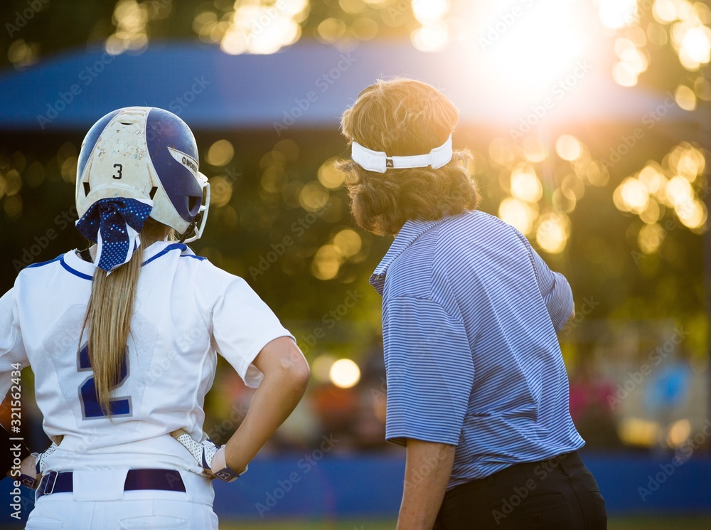Softball Player & Coach on Third Base Stock Photo | Adobe Stock
