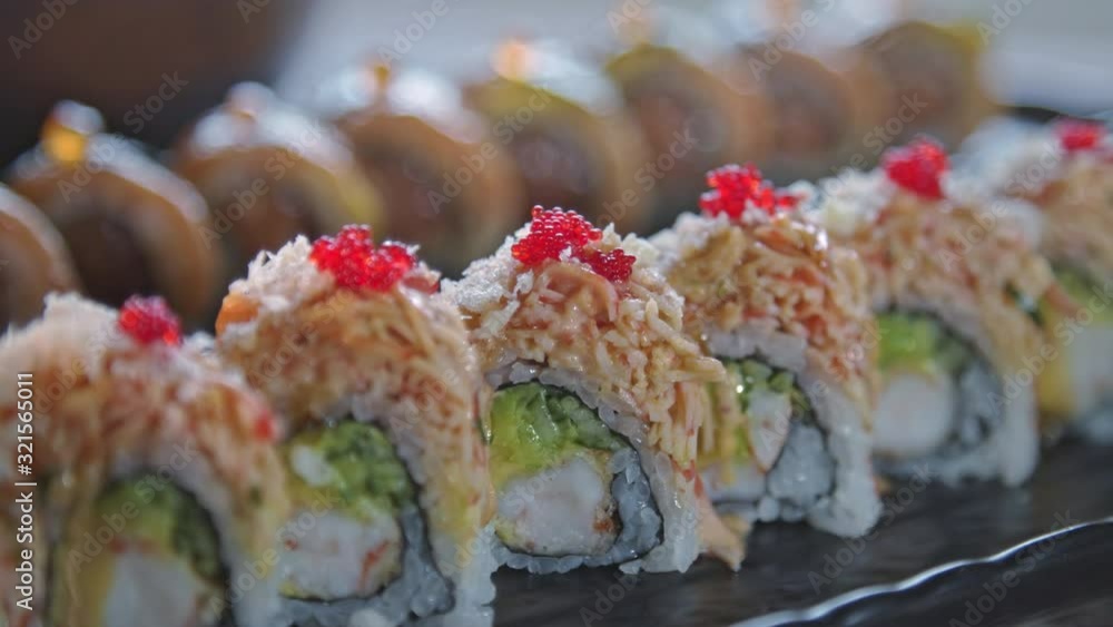 beautiful volcano sushi roll with kani, cucumber, avocado, spicy tuna ...