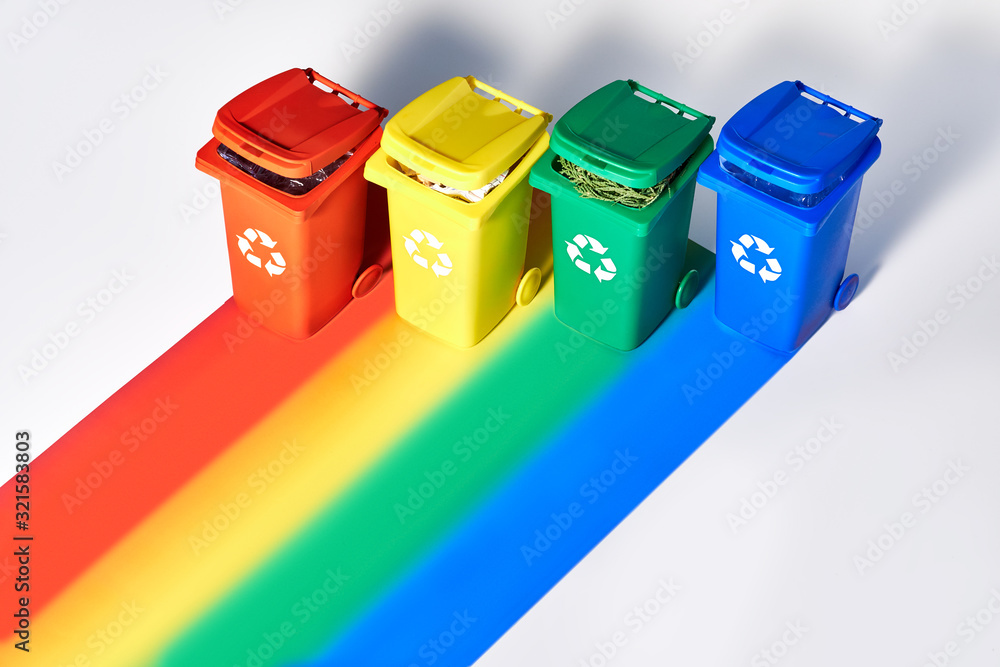 Four color coded recycle bins, isometric projection on geometric ...