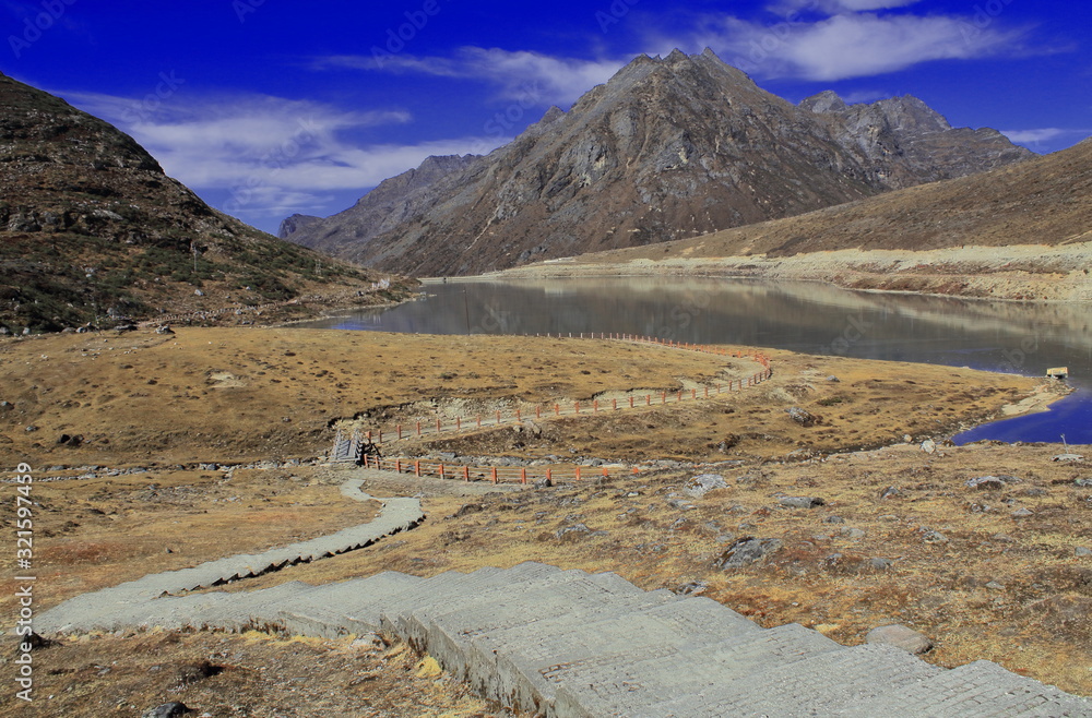 the stairway going through the alpine landscape to the scenic sela lake ...