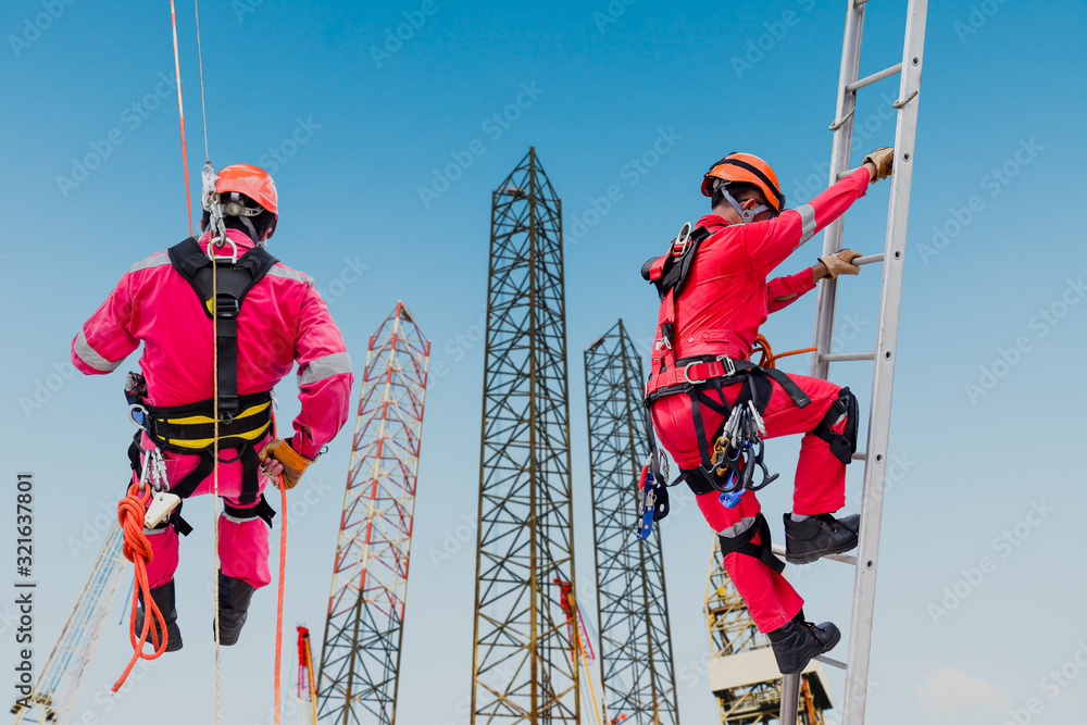 Zdjęcie Stock: Team Safety man worker Abseiling from tower climber and ...
