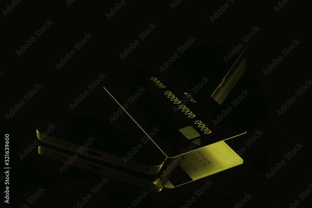 Credit card on mobile phone close up on monochromatic background ...