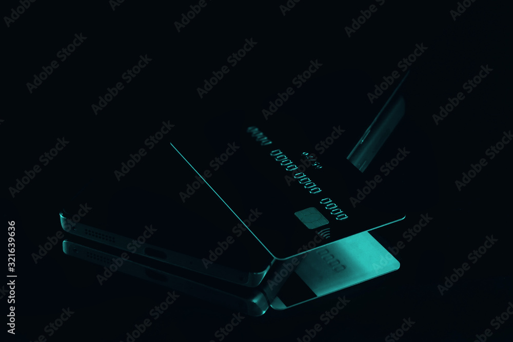 Credit card on mobile phone close up on monochromatic background ...