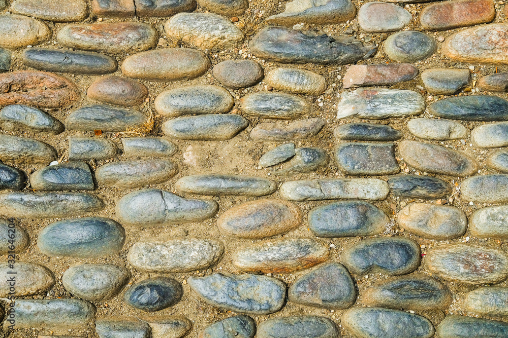 Ancient Roman road surface paved by cobblestone, Spain. Background and ...