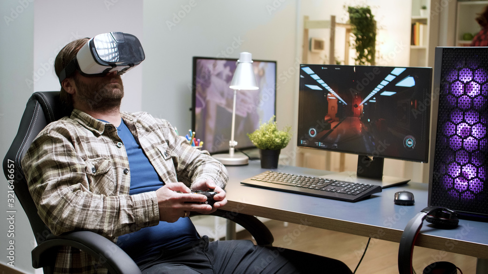 Man sitting on gaming chair taking off his vr headset Stock Photo ...