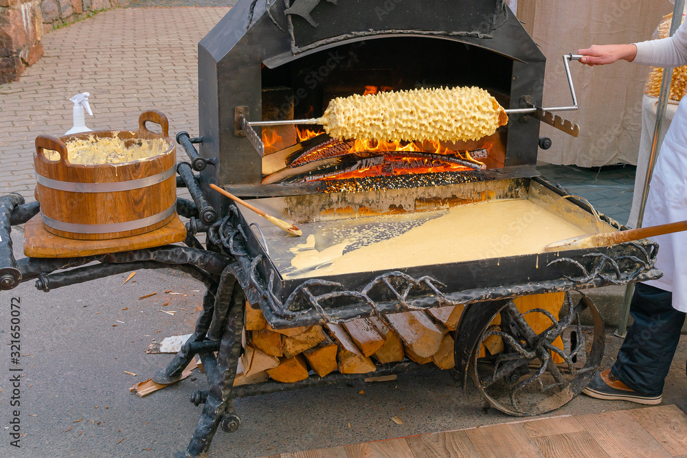 Women on the street at the wood stove are preparing Lithuanian tree ...