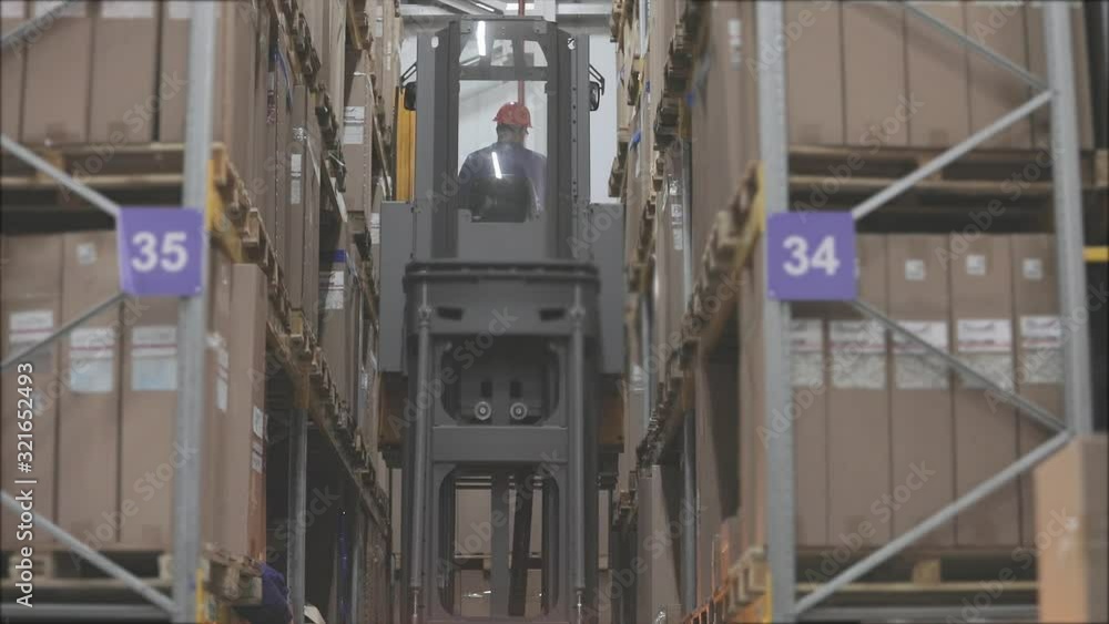 Forklift with lift cabin, modern forklift in a large modern warehouse ...