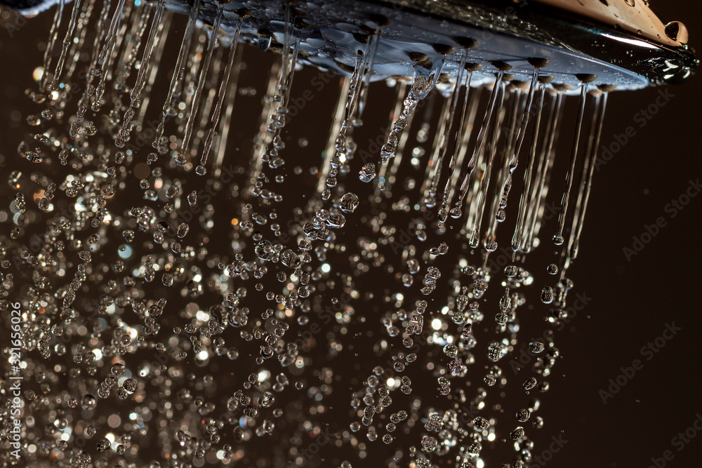 Shower head and falling water drops. Stock Photo | Adobe Stock
