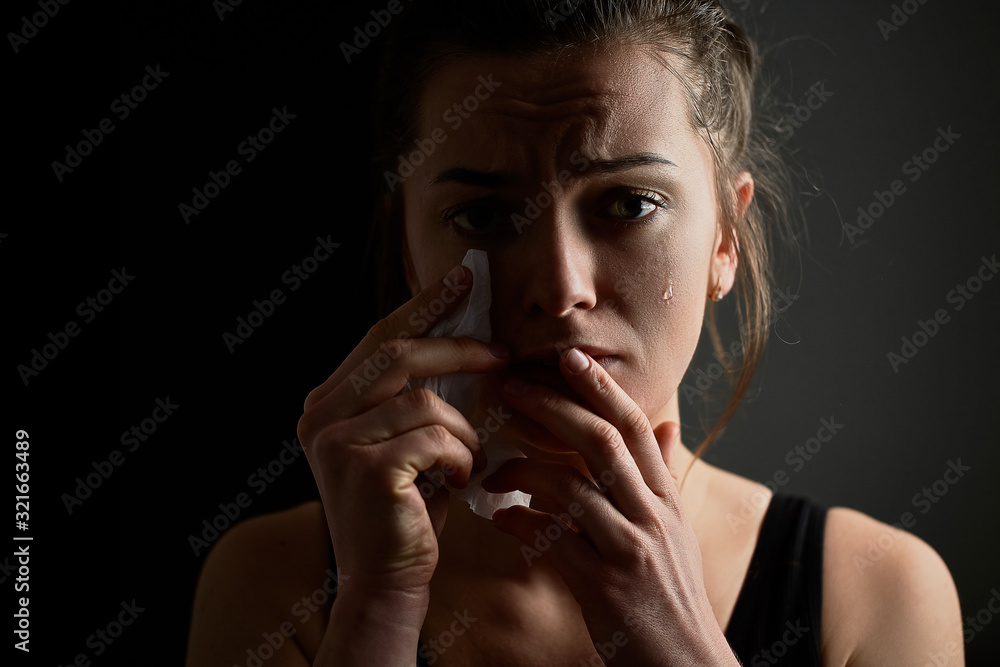 Sad miserable desperate grieving crying woman with tears eyes on a dark ...