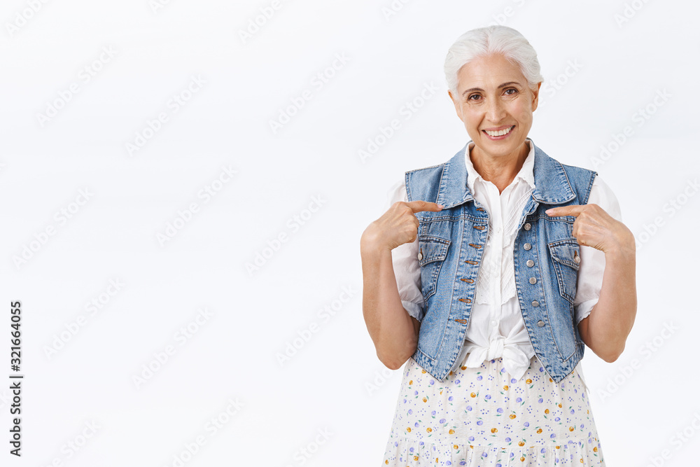 Cute happy smiling old woman with grey hair, wear stylish denim vest ...