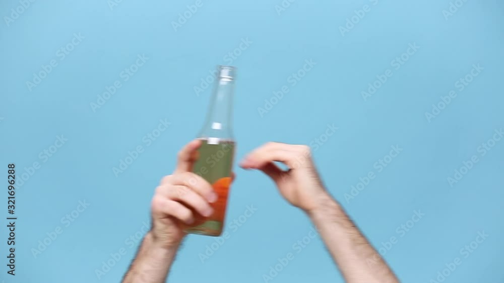 Close up cropped man hands hold lager beer glass bottle and showing ...
