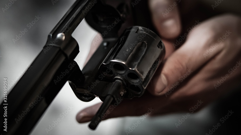 Man inspecting the chamber of a .38 special revolver. Close up of ...
