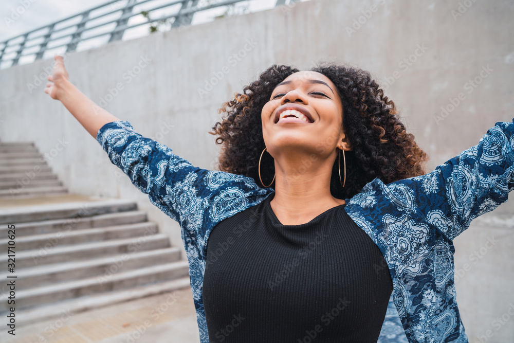 Afro american woman with arms raised. Stock Photo | Adobe Stock