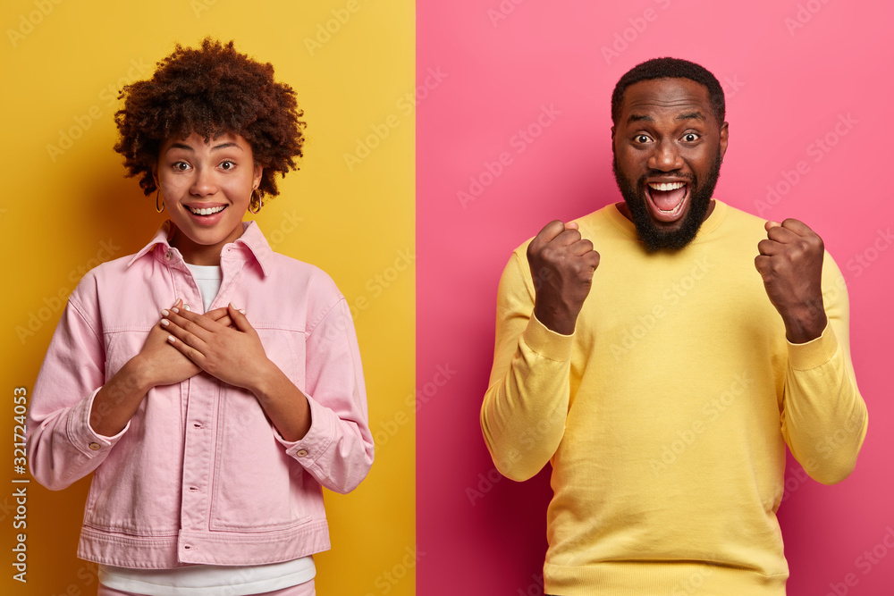 Portrait of pleased thankful woman keeps hands on chest, expresses ...