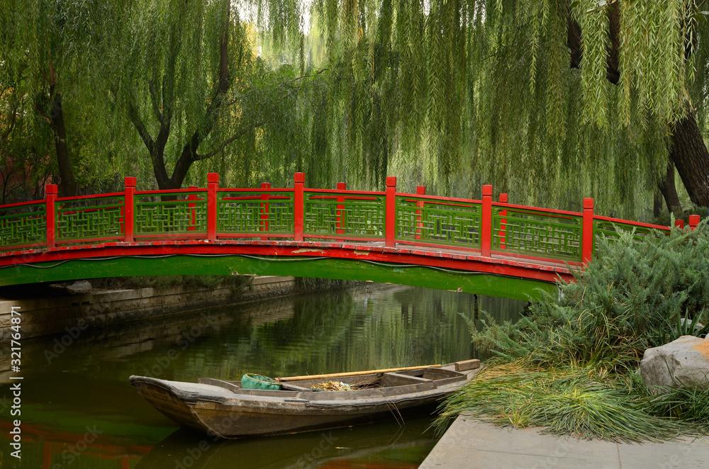 Old bridge over Changpu river with boat and willow trees in Beijing ...