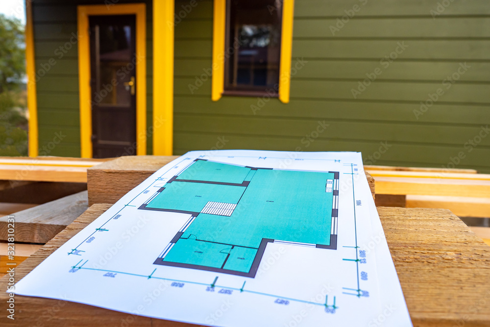 Building plan on the background of the cottage. Layout of the premises ...