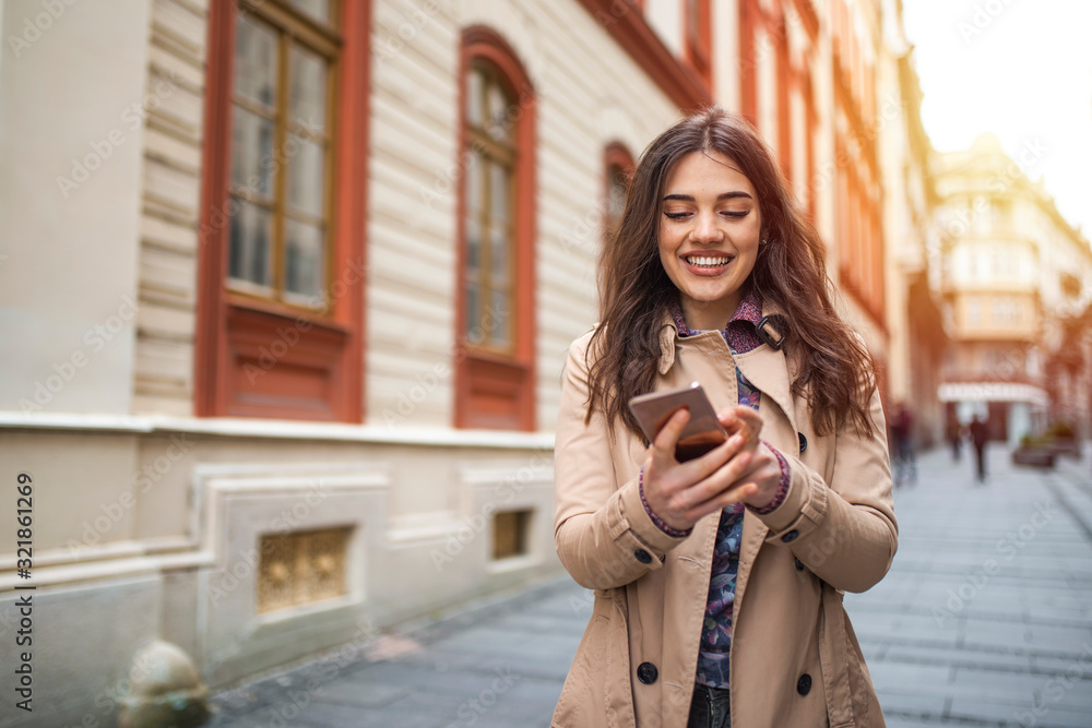 Street life. Business woman with phone on the street. Beautiful young ...