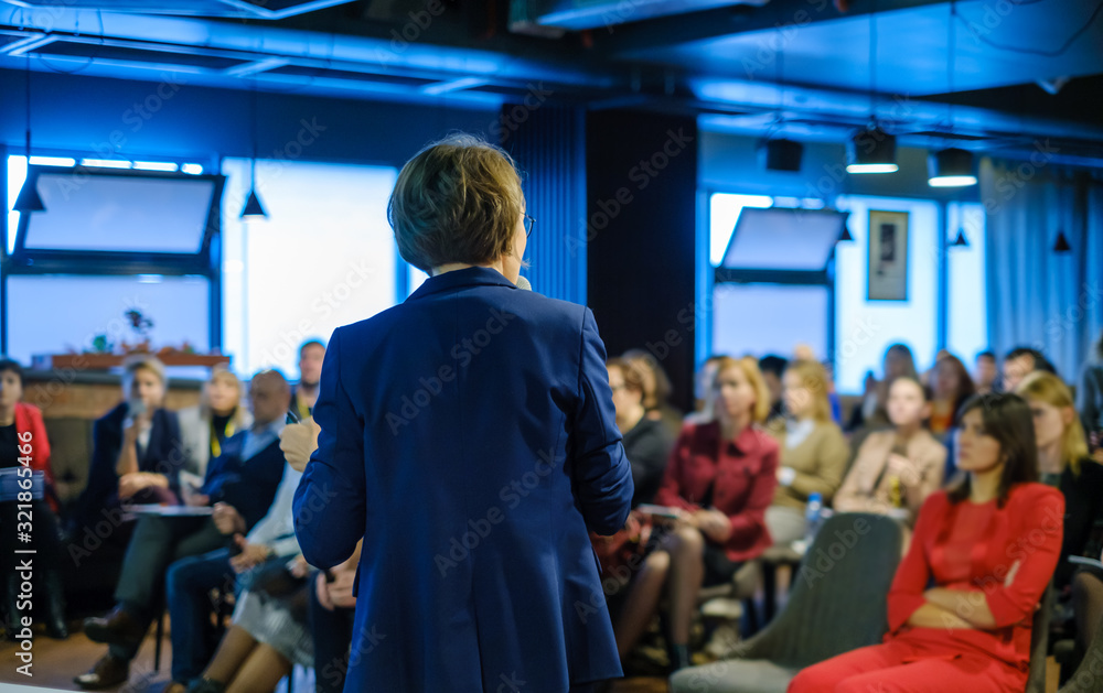 Female presenter speaks to audiences Stock Photo | Adobe Stock