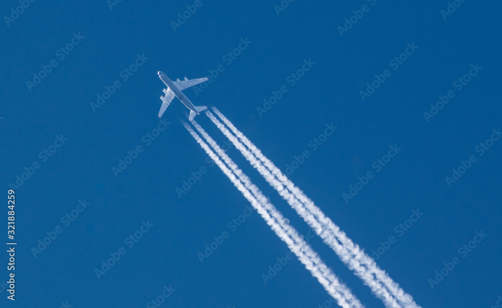 Aircraft at high altitude. Antonov AN 124 cargo plane on a blue sky ...