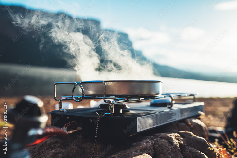 camping cooking in nature outdoor, prepare breakfast picnic in mist ...