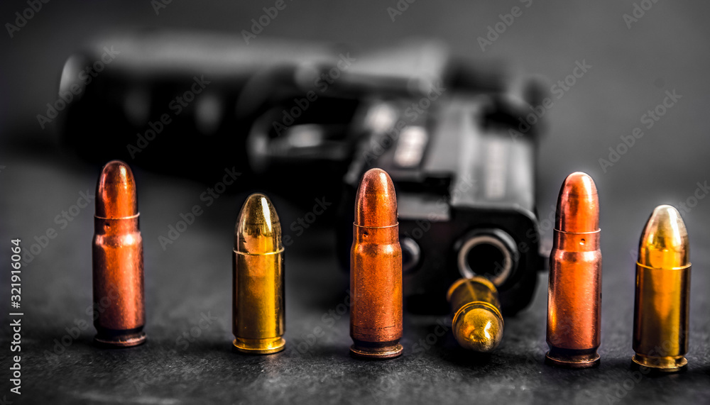 Bullets and handcuffs. Close-up of 9mm pistol. Gun and weapon with ...