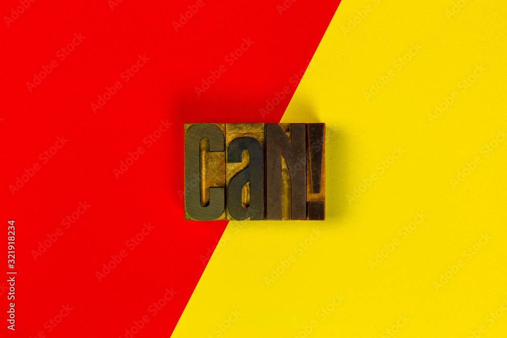 written can! with wooden printing characters on a two-tone background ...