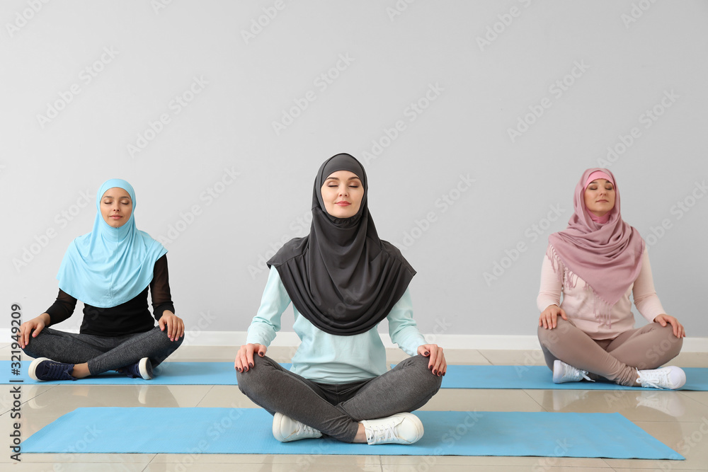 Sporty Muslim women practicing yoga in gym Stock Photo | Adobe Stock
