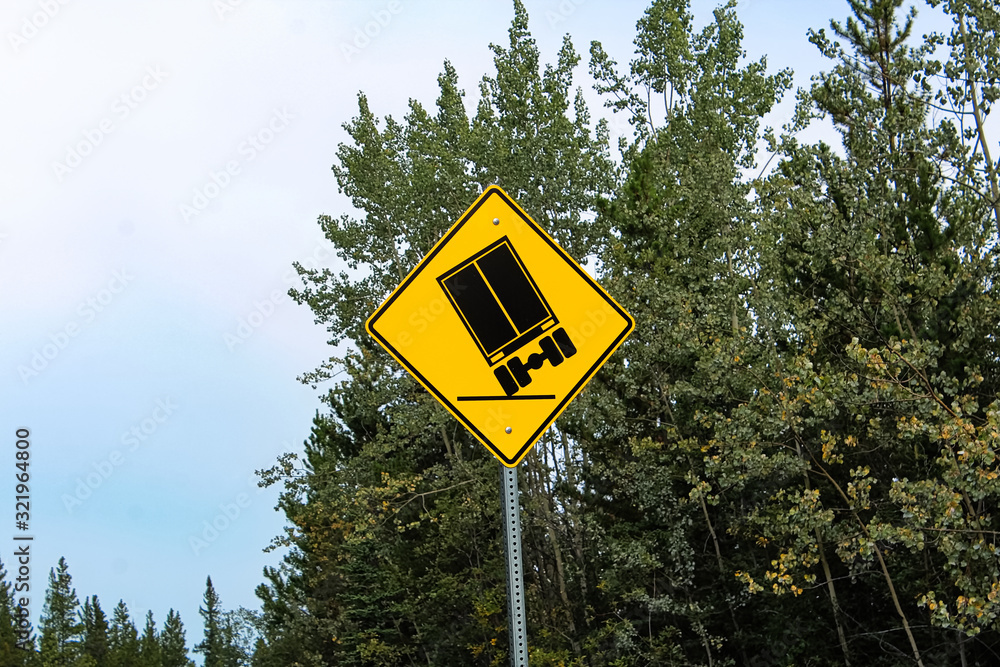 A truckers warning sign about tipping hazards Stock Photo | Adobe Stock