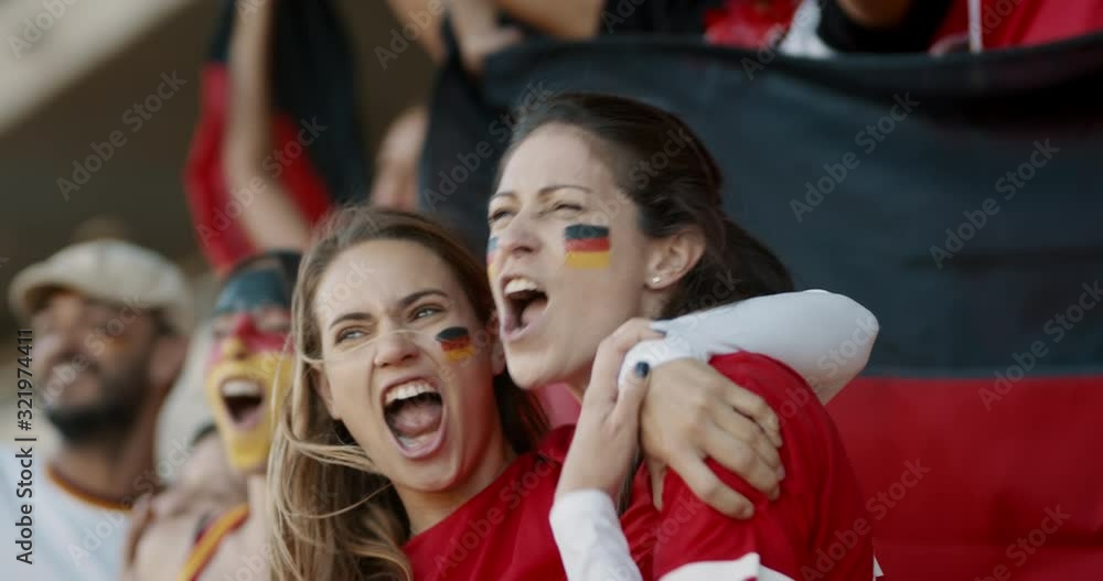 Two german female friends enjoying watching a game. German soccer fans ...