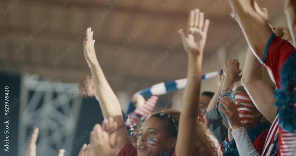 Sports fans with US flags clapping hands in stands. American team ...