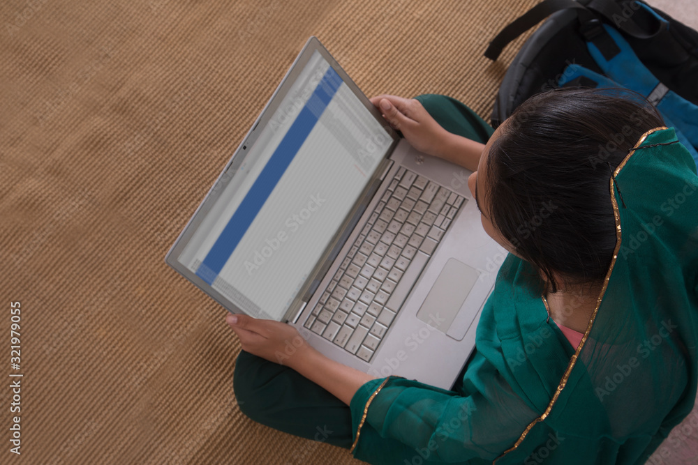 Portrait of rural girl using laptop Stock Photo | Adobe Stock