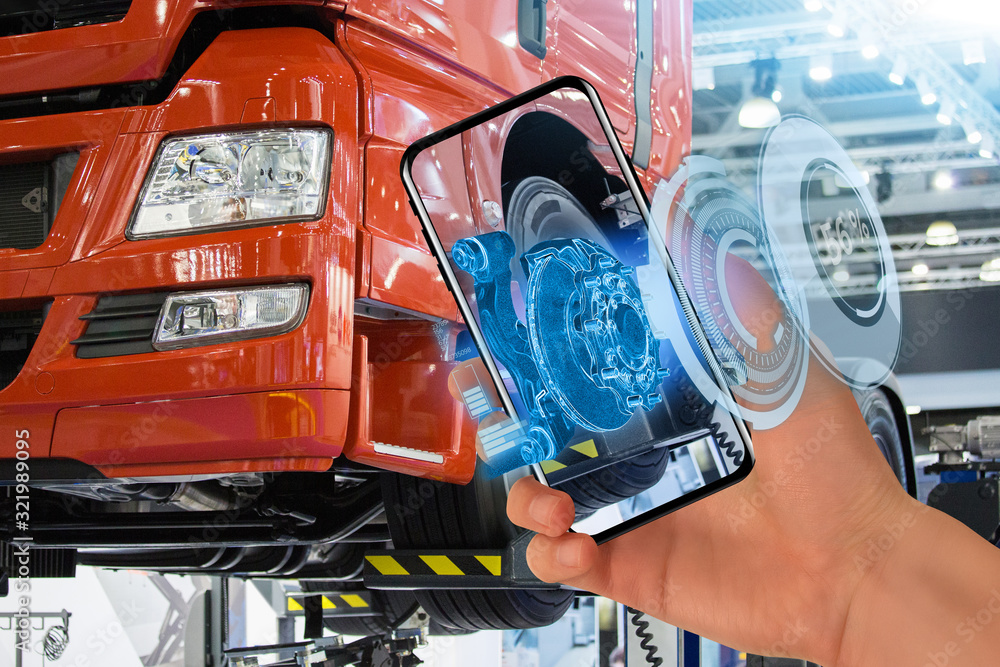 Serviceman repairing a truck using augmented reality application. Stock ... Serviceman repairing a truck using augmented reality application. Stock ...