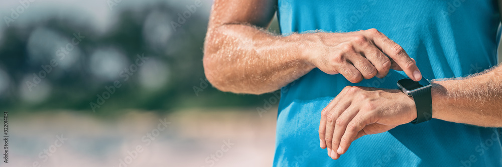 Runner man athlete checking heart rate monitor during workout on ...