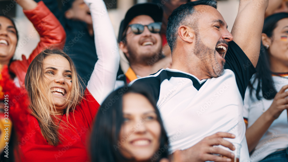 Excited crowd of sports fans cheering in stadium Stock Photo | Adobe Stock