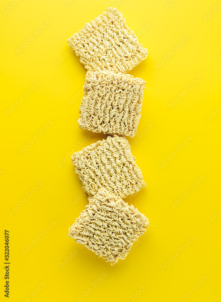 Four dry instant noodles blocks on vibrant yellow background. Flat ...