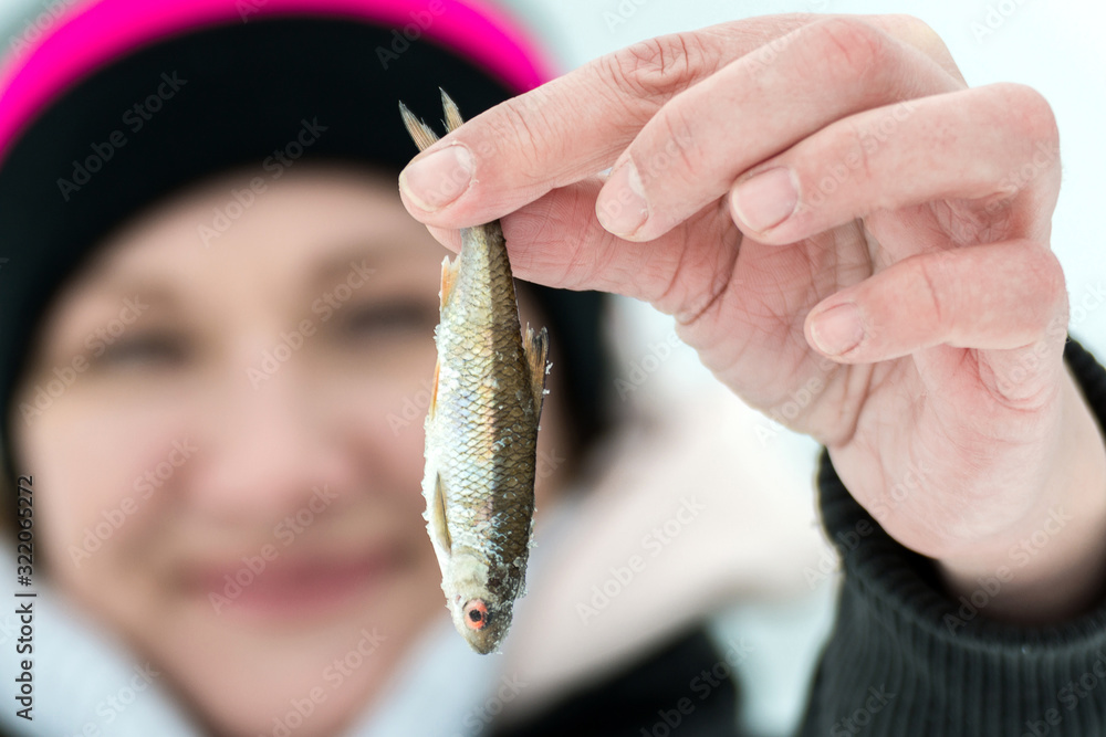 The girl on the fishing caught a very small fish, shows everyone her ...