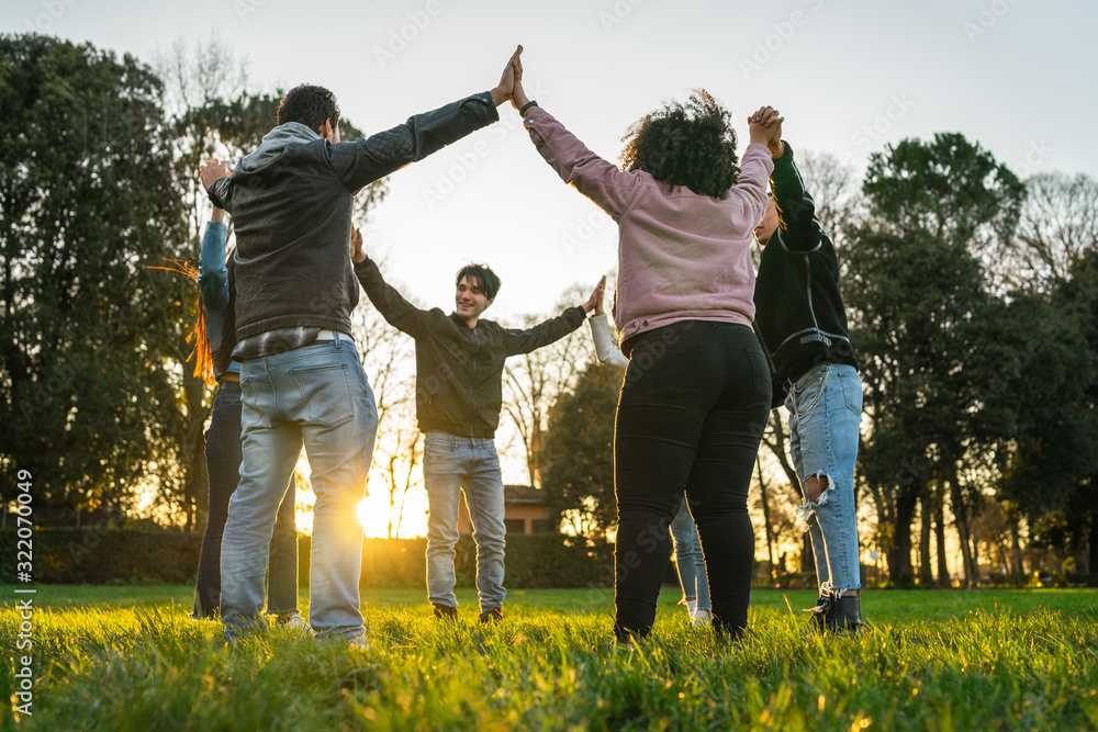 Group of ten friends at the park holding hands - Teamwork - Concept of ...