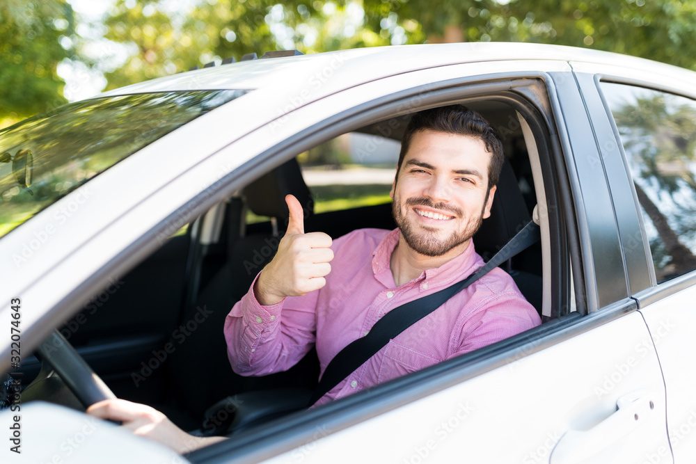 Foto de Man In New Car Showing Thumbs Up do Stock | Adobe Stock