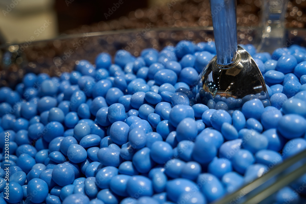 Chocolate candies in blue glaze. Colorful dragees. Blue jelly beans ...