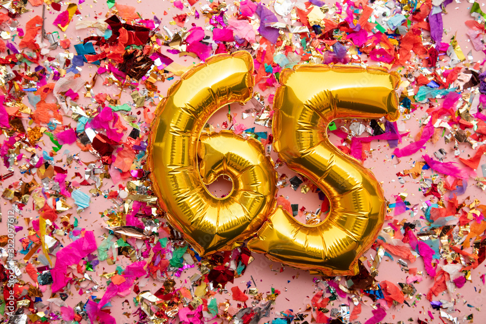 Number 65 gold birthday celebration balloon on a confetti glitter ...
