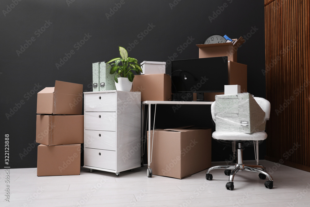 Cardboard boxes and packed belongings in office. Moving day Stock Photo ...