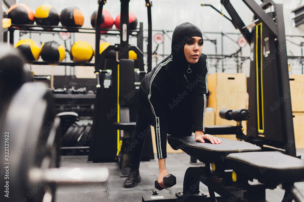 Muslim asian woman in hijab exercizing in a gym. Stock Photo | Adobe Stock