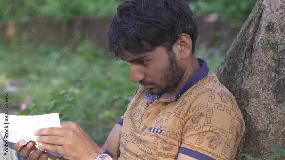 A drunk man sitting below a tree.Drunk Indian man looking tired. A ...