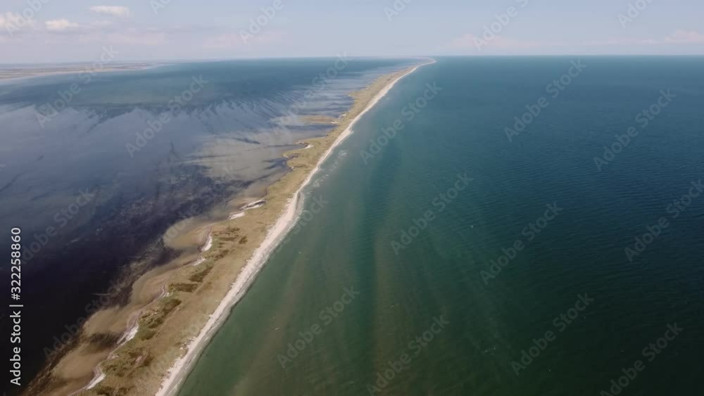 Aerial shot of an upright sand spit at the Black Sea shallow in sunny ...