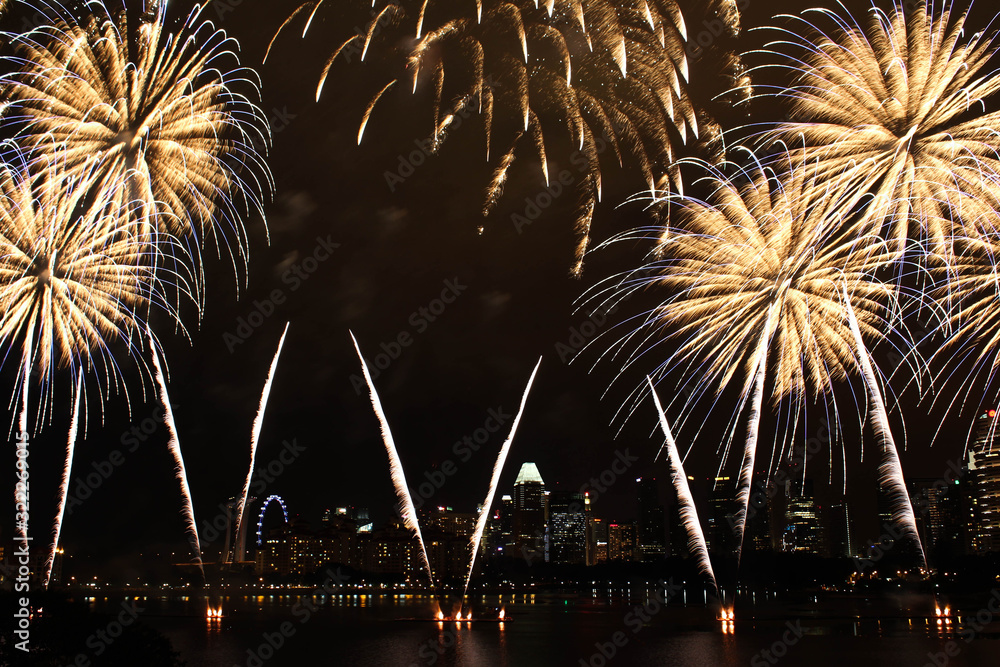 Blue and yellow fireworks in front of Singapore city skyline Stock ...
