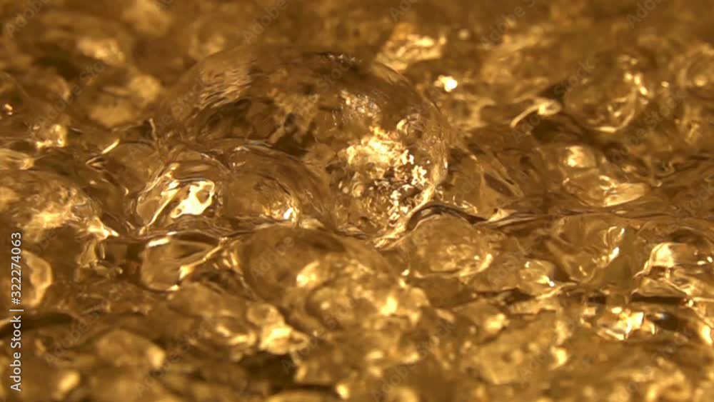 Golden boiling liquid. Intense seething. Visual imitation of molten ...