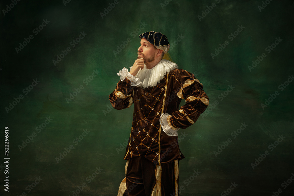 Posing thoughtful. Portrait of medieval young man in vintage clothing ...