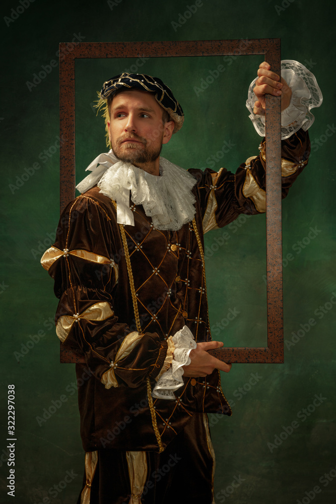 Posing thoughtful. Portrait of medieval young man in vintage clothing ...