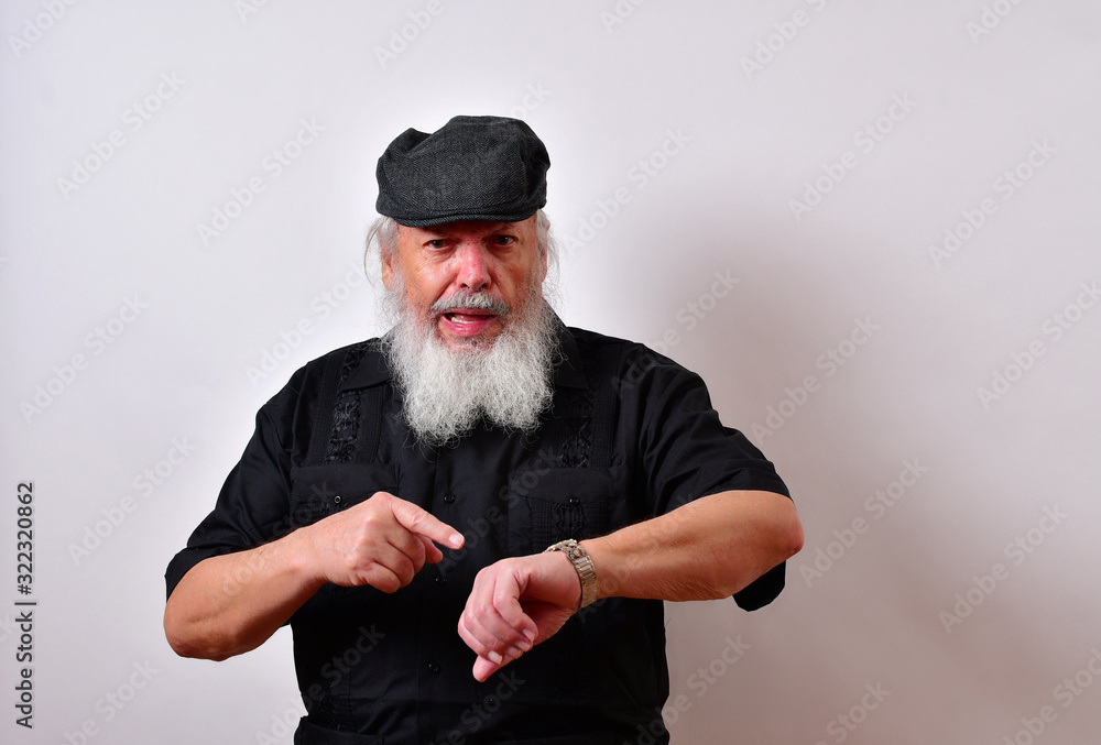 Impatient old man with a scowl on his face pointing at his watch ...