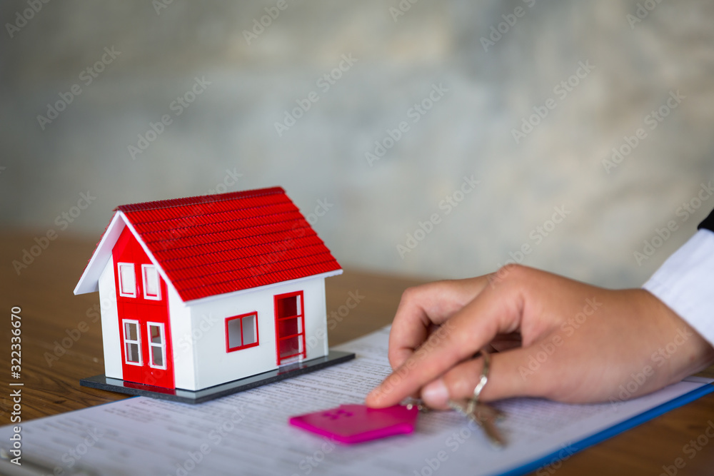 The house dealer holds the red roof house and holds the key to the ...
